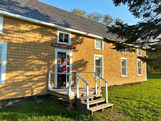 The Maison Hammond-Laplante bathes in golden afternoon light. This preserved Acadian home showcases the distinctive architectural style that defined early settlement.