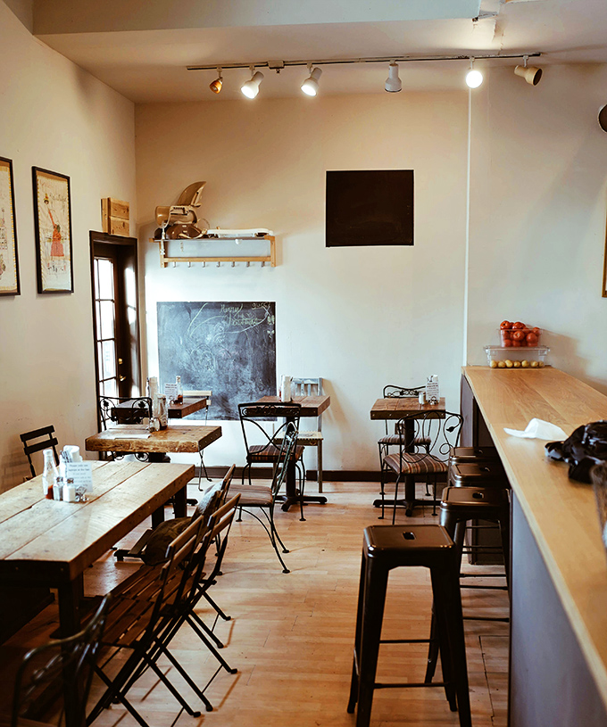 Minimalist charm defines this cozy caf&eacute; where wooden tables and track lighting create the perfect backdrop for caffeine-fueled conversations.