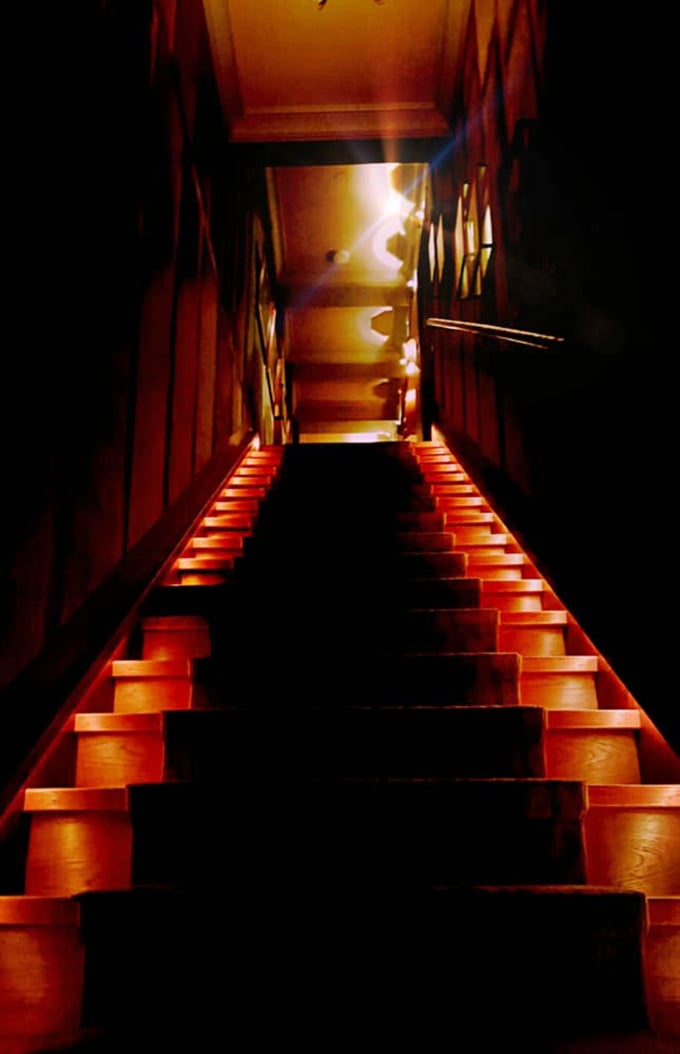 These dramatically lit stairs beckon you upward, promising yet another layer of mystery waiting to be discovered above.