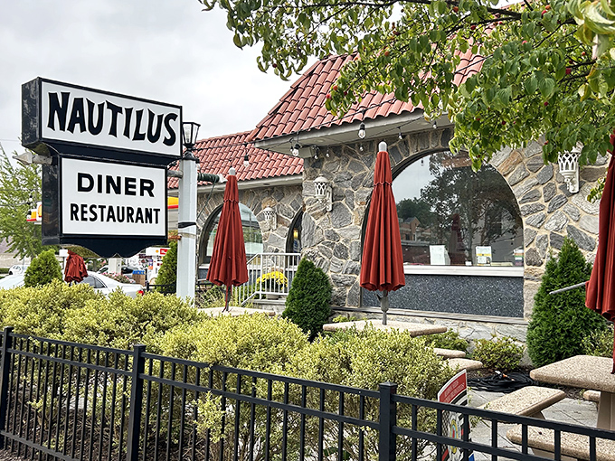 The Nautilus Diner's stone facade and red umbrellas promise comfort food classics served with a side of nostalgia and bottomless coffee.
