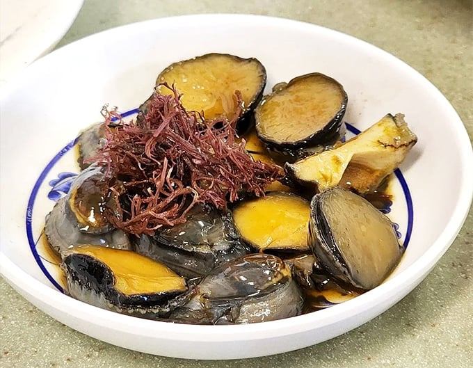 Century eggs nestled among vegetables &ndash; a delicacy that rewards the adventurous eater with complex flavors and surprising textures.