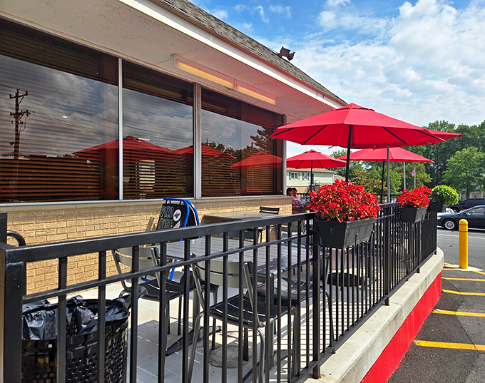 Red umbrellas dot the patio like cherry tops on sundaes, offering al fresco dining with a side of people-watching.