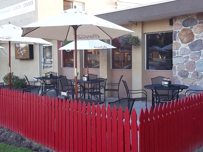 Outdoor seating bordered by a cheerful red fence&mdash;because sometimes pancakes taste even better with a side of fresh air.