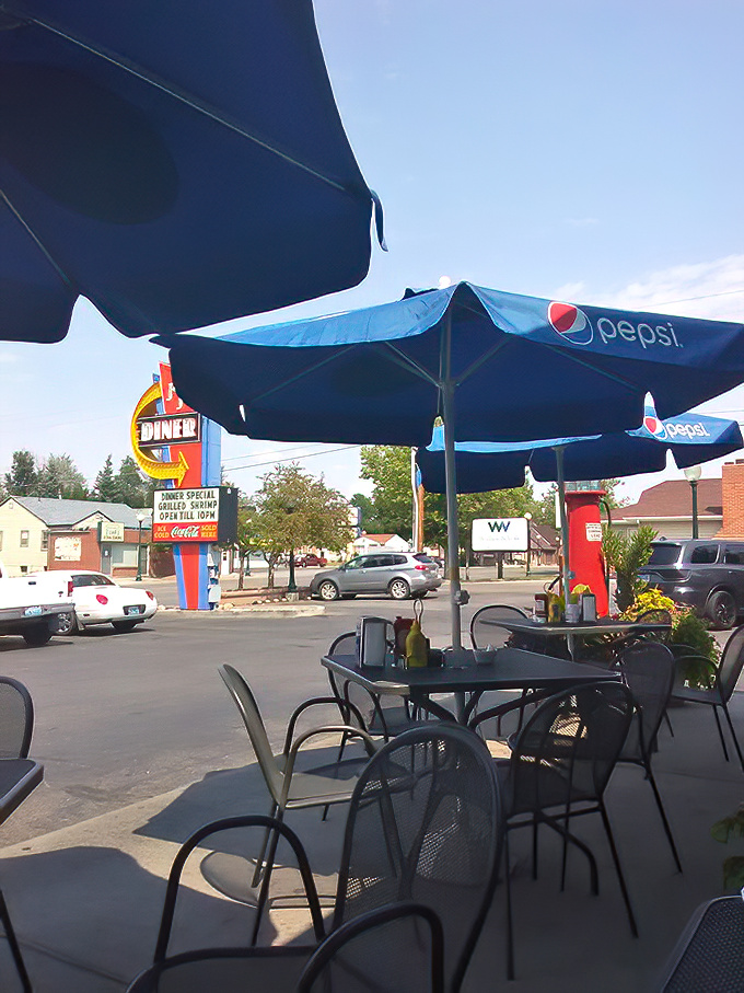 Summer in Wyoming means patio dining under Pepsi umbrellas, where the iconic Johnny J's sign serves as a landmark for locals giving directions across town.