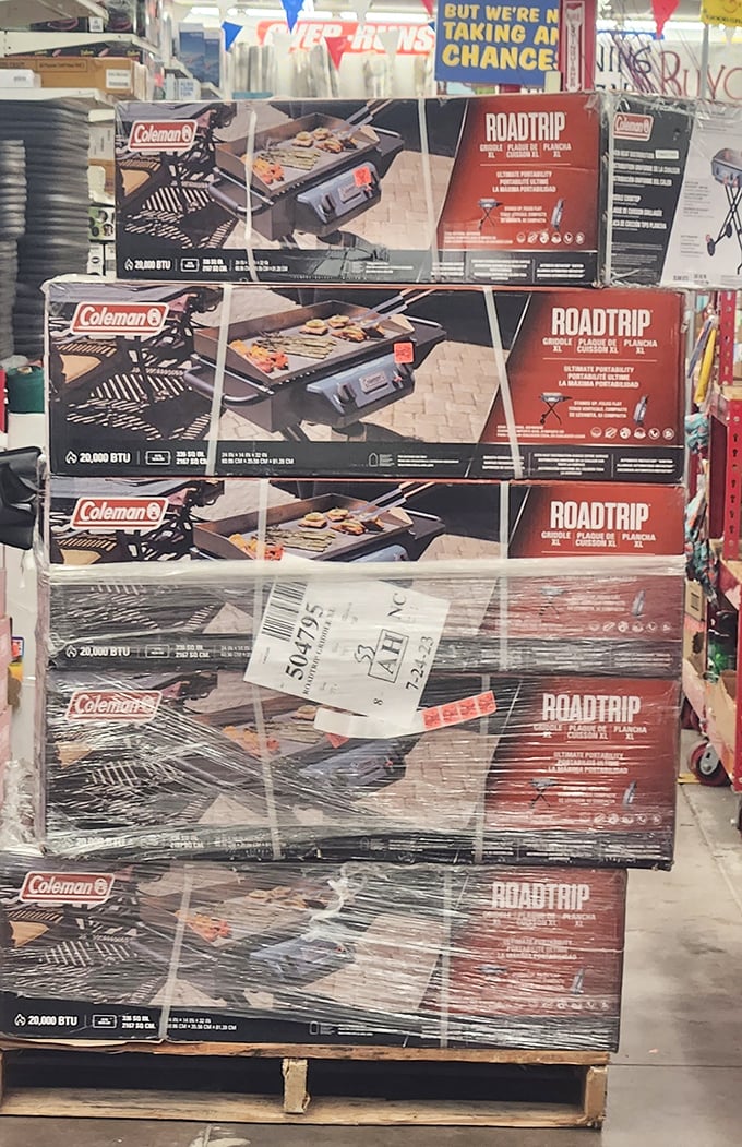 Coleman grills stacked like a monument to summer cookouts, ready to transform backyard chefs into neighborhood legends.