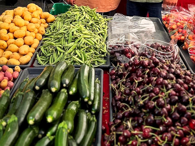 Nature's jewel tones on display&mdash;cherries, zucchini, and snap peas arranged like an edible artist's palette.