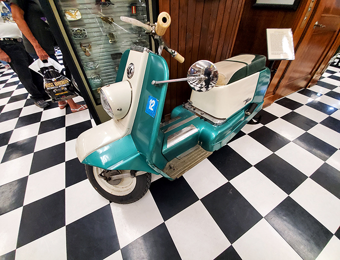 This teal scooter represents the sophisticated European cousin who showed up at the American motorcycle family reunion&mdash;stylish, practical, and slightly judgmental.