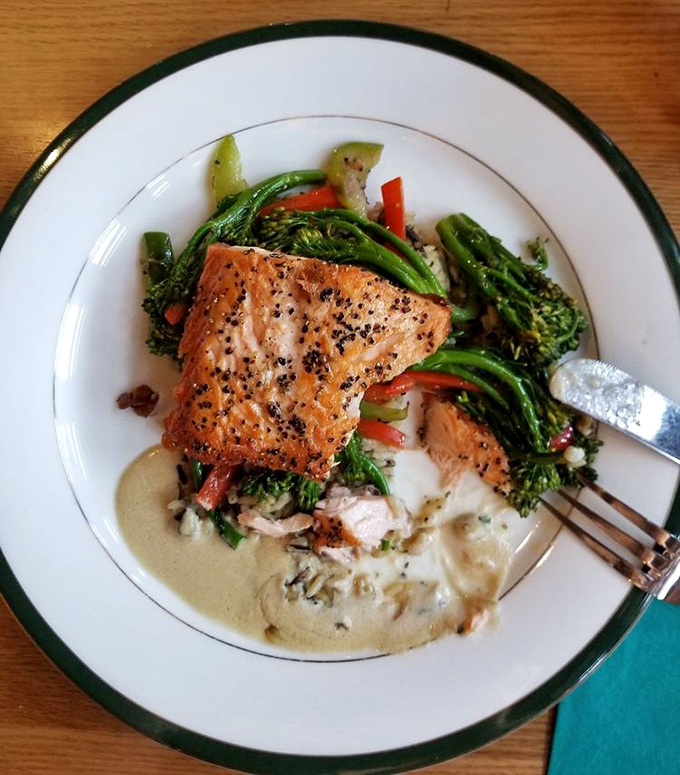 Salmon that's been treated with respect &ndash; perfectly seared, resting on vegetables, with a sauce that whispers "I could have been basic, but chose excellence instead."