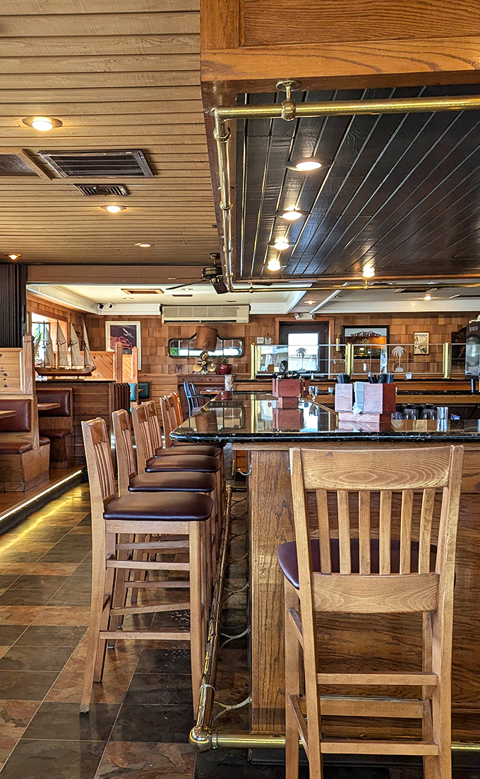 Bar seating that strikes the perfect balance between "I'm here for serious eating" and "I might make a new friend." The brass footrail is just a bonus.