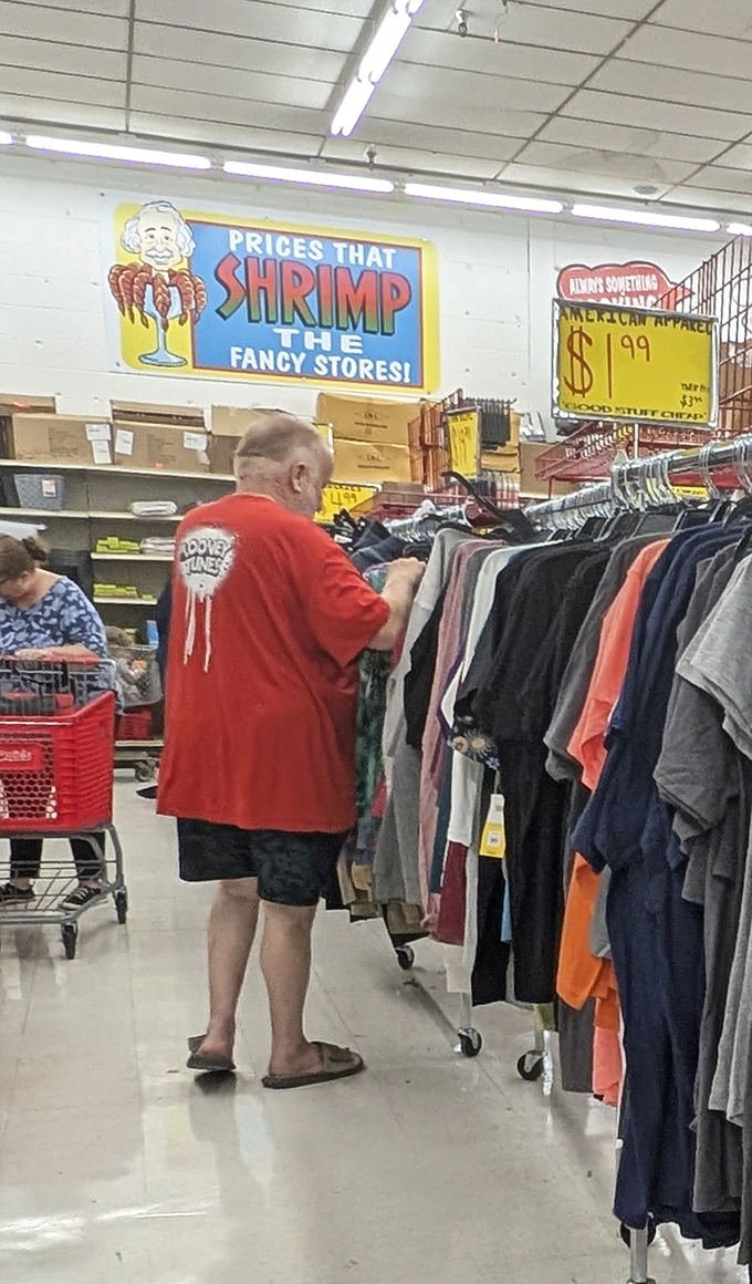 Shoppers in their natural habitat, hunting for treasures under signs promising "Prices That Shrimp The Fancy Stores!" Retail therapy at its finest.
