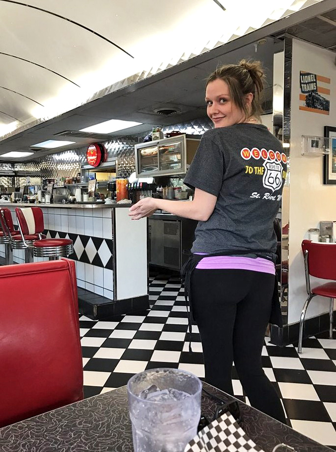 Service with a smile and a t-shirt that says it all. Route 66 isn't just a highway—it's a state of mind.
