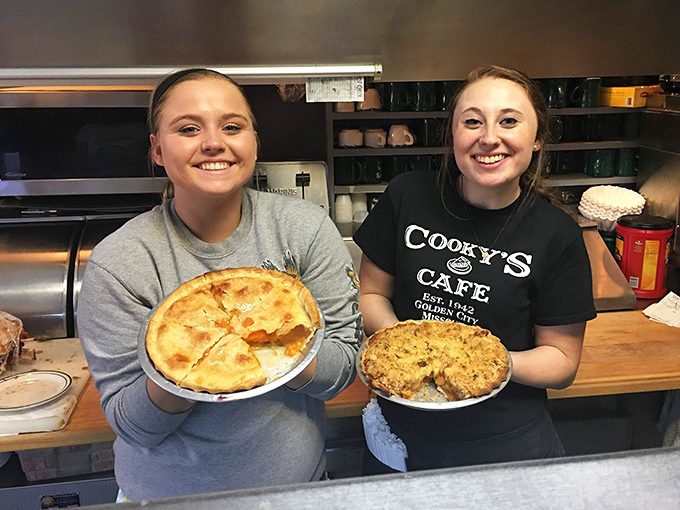 The pie ambassadors! Fresh-baked goodness held by the hands that create these circular masterpieces of fruit and crust.