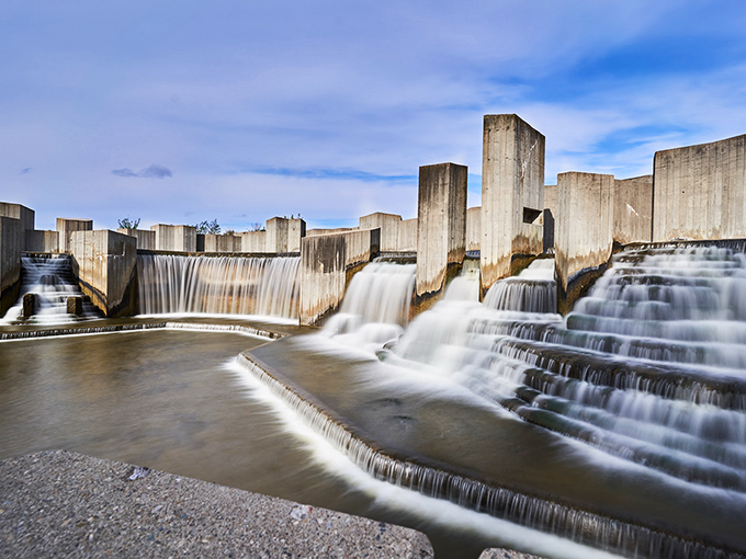 Stepping Stone Falls cascades dramatically over concrete terraces, a human-made wonder that brings unexpected serenity to urban Flint.