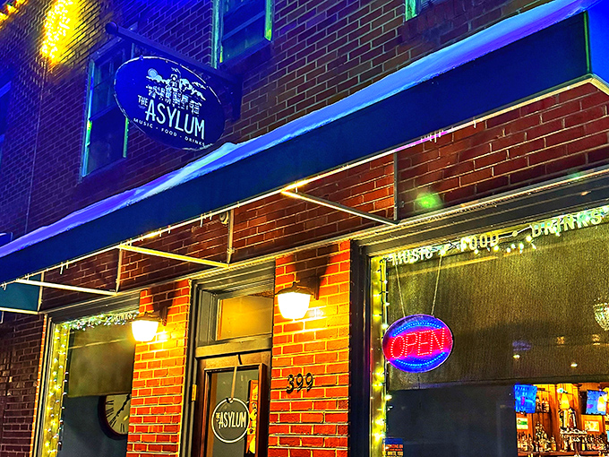 The Asylum glows with evening promise, its brick fa&ccedil;ade and blue lighting creating the perfect backdrop for night owls seeking entertainment.