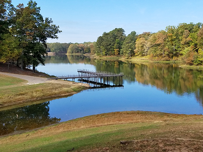 Tombigbee State Park's glassy waters mirror autumn's approach. This peaceful dock invites contemplation about life's simple pleasures in Mississippi's natural splendor.