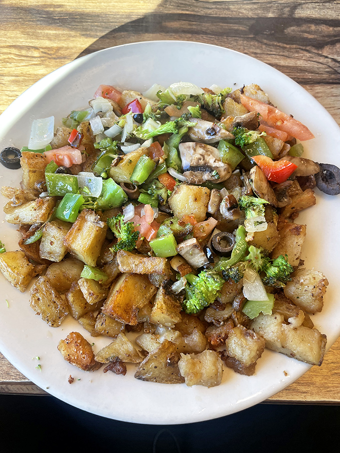 Veggie home fries &ndash; where potatoes become a canvas for broccoli, peppers, and olives in a breakfast masterpiece.
