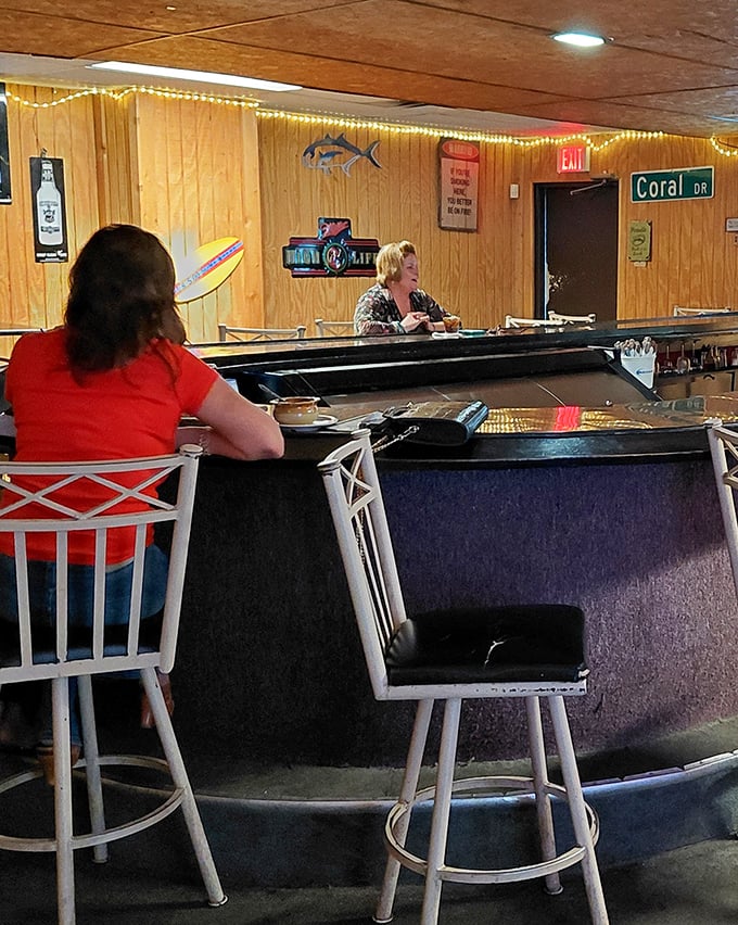 The Little Bar's wood-paneled charm offers the perfect spot to wait for your table or swap fishing tales over a cold one.