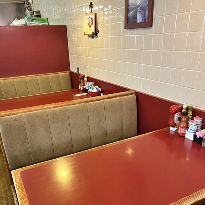 Cozy booths offer sanctuary for intimate conversations or solo dining adventures with condiments standing ready for duty.
