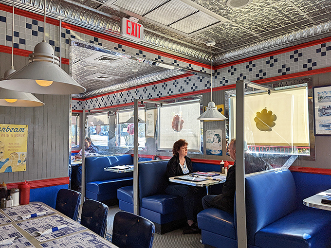 Those blue booths have heard more Rhode Island stories than any therapist in the state. The pressed tin ceiling reflects both light and decades of diner tradition.