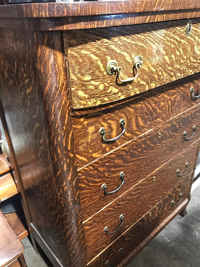 This tiger oak dresser has survived a century of use, its brass handles polished by countless hands before yours.