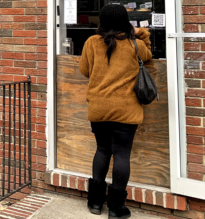 The universal posture of anticipation&mdash;a customer at the counter about to experience that first bite of donut bliss.