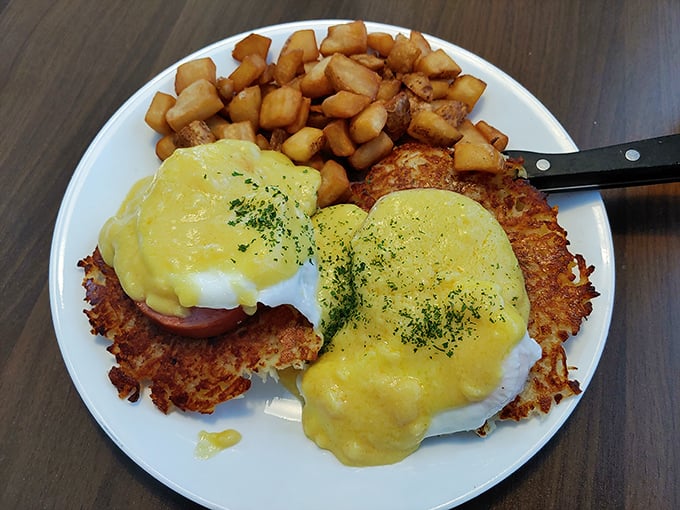 Potato pancake benedict that defies gravity – crispy hash brown discs supporting poached eggs under a sunshine-yellow hollandaise waterfall. Breakfast architecture at its finest!