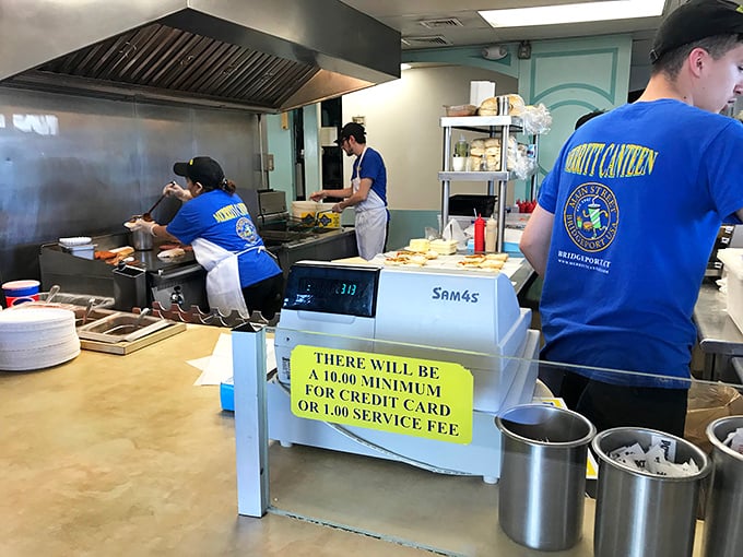 Behind the counter, the kitchen crew moves with the choreographed precision of people who've turned fast food into an art form.