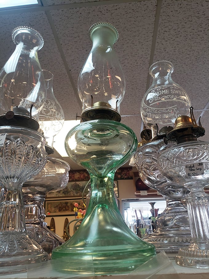These vintage oil lamps have illuminated countless family dinners and late-night readings, their glass bases catching light like liquid jewels.