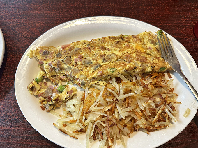 This perfect omelet with crispy hash browns demonstrates why breakfast might actually be the most important art form of the day.