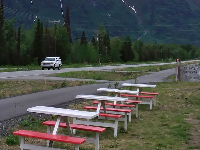 Red and white picnic tables waiting for hungry travelers. The best seats in Palmer don't require reservations, just an appetite.