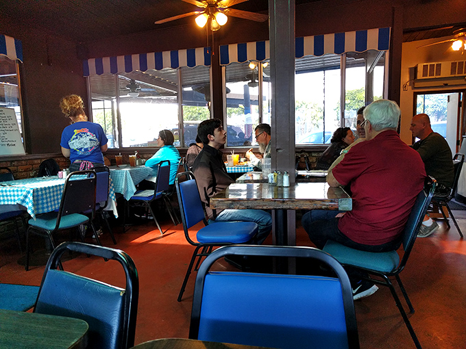 Where strangers become neighbors over eggs and coffee. Those blue chairs have heard more local stories than any therapist in town.