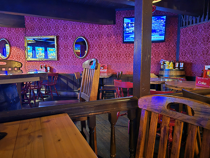 Pink wallpaper and wooden tables create an unexpected contrast&mdash;like finding a touch of Victorian parlor in your authentic Western saloon experience.