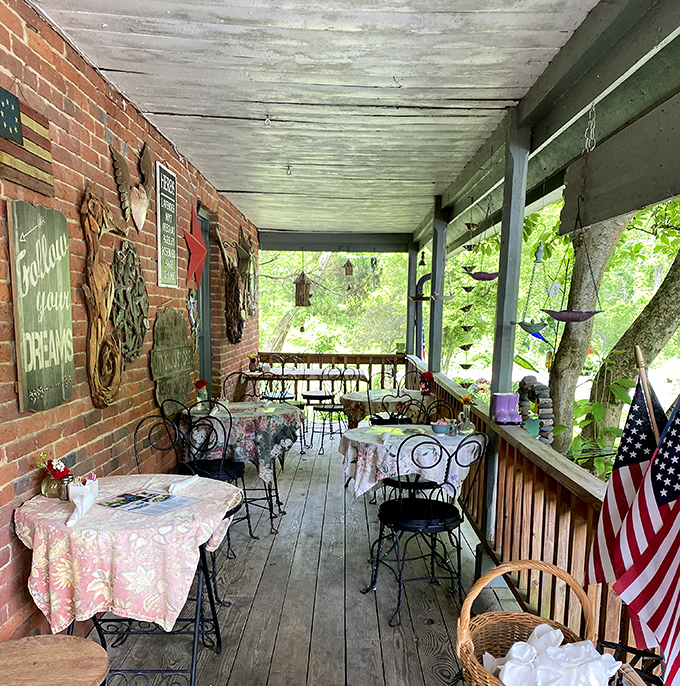 The covered porch seating area feels like dining in a secret garden, where every table offers a different perspective on relaxation.