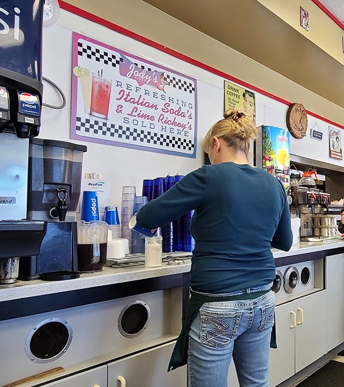 Where the magic happens – skilled hands preparing the next round of coffee, keeping the lifeblood of the diner flowing for grateful patrons.
