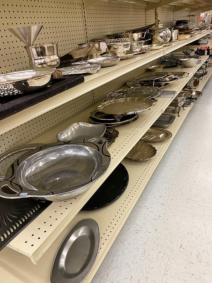 Silver serving pieces gleaming under fluorescent lights &ndash; from elegant trays to practical platters, entertaining made affordable.