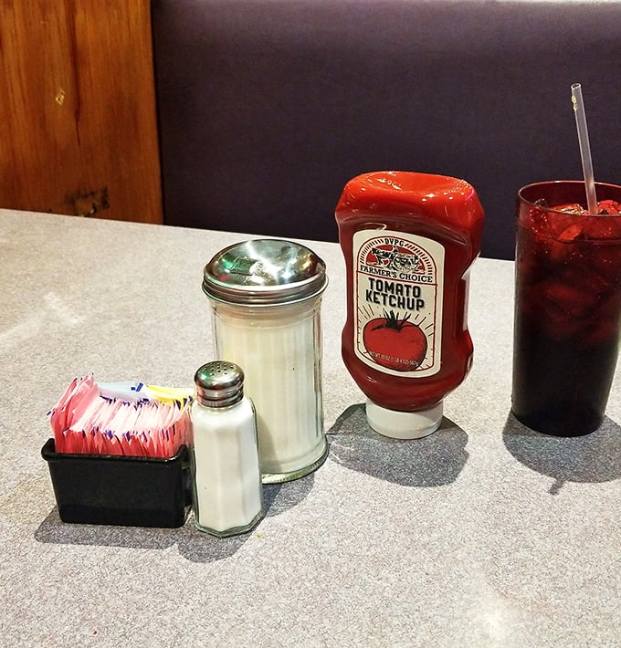 The holy trinity of diner condiments&mdash;sugar, salt, and ketchup&mdash;standing guard over countless breakfast conversations.