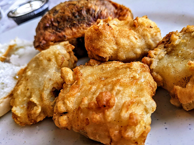 Beer-battered cod chunks so perfectly golden and puffy, they look like they're trying to float right off the plate and back to the lake.
