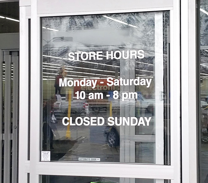 The store hours sign&mdash;your guide to planning bargain expeditions with military precision. Note the Sunday closure for recovery from Saturday's deals.