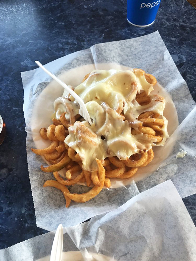 Curly fries smothered in melted cheese&mdash;because sometimes subtlety is overrated and what you really need is unapologetic, delicious excess.