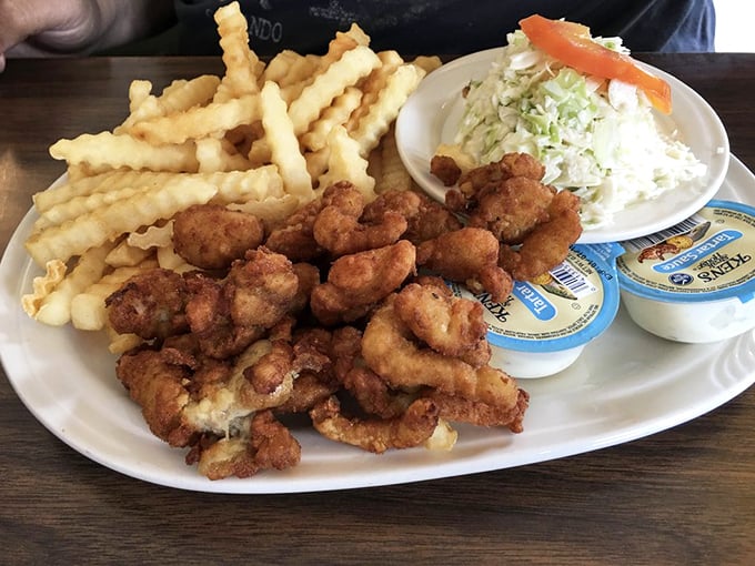 Fried clams that snap with freshness, crinkle-cut fries that hold their own, and coleslaw that cuts through richness with perfect balance.
