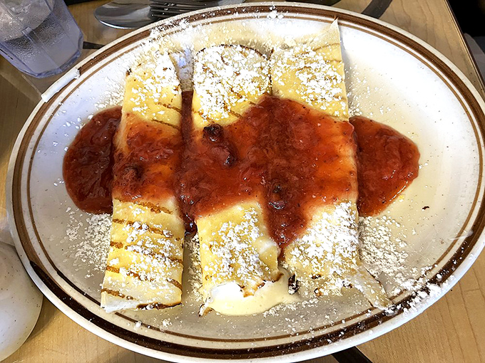 Sweet crepes dusted with powdered sugar and drizzled with fruit sauce &ndash; breakfast's way of saying it can do dessert better than dessert can.