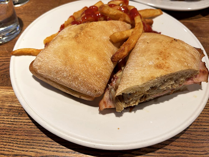 The Cubano arrives pressed to perfection, its layers of pork and ham creating sandwich architecture worth celebrating.