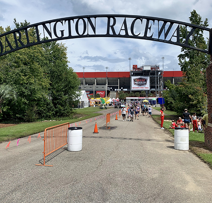 The iconic arch of Darlington Raceway welcomes racing enthusiasts to hallowed ground where NASCAR legends are born and ordinary drivers dare not tread.