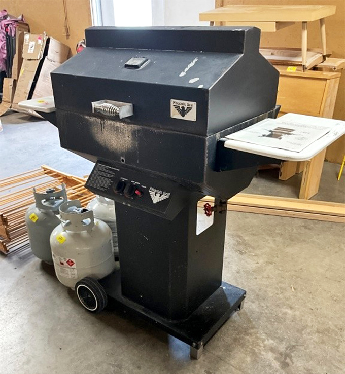 A grill that's seen its share of summer cookouts stands ready for its next burger flip. The patina tells of Fourth of Julys past.