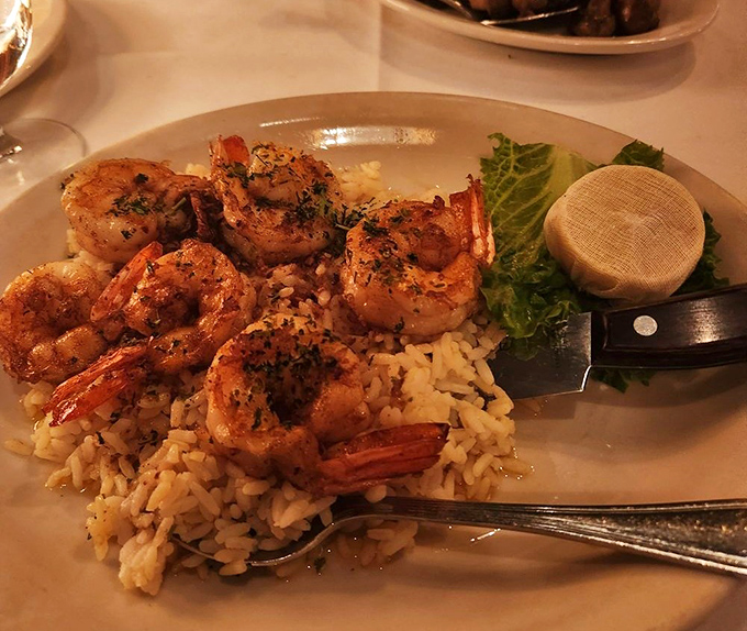 Greek-style shrimp nestled on a bed of rice &ndash; proof that Lewnes' mastery extends beyond beef to the bounties of the Mediterranean.