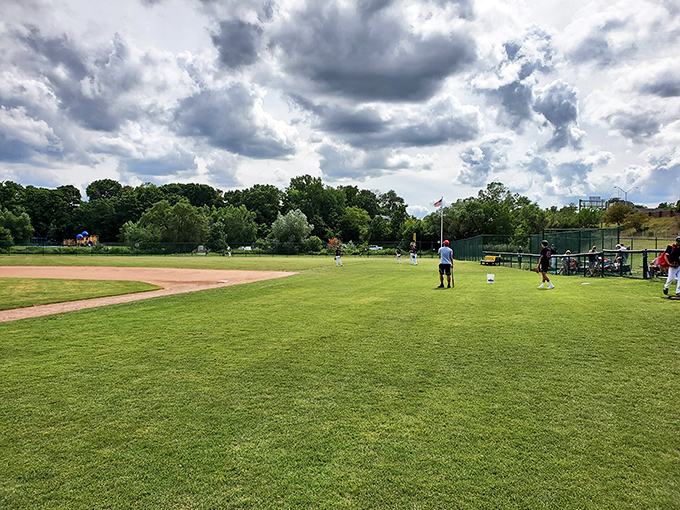 Kearsley Park's baseball diamond awaits its next game, where community comes together under Michigan's expansive summer skies.