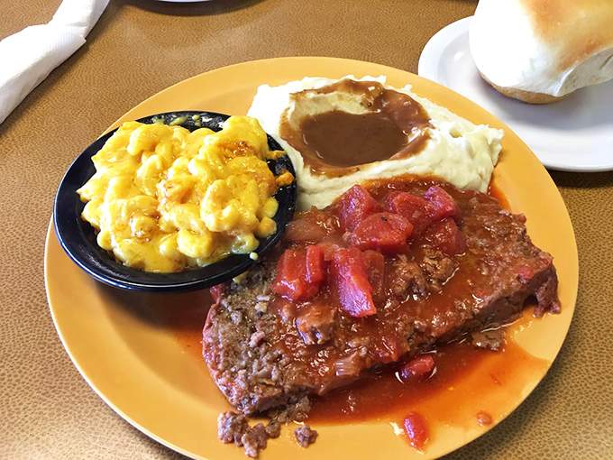Meatloaf with tomato glaze alongside creamy mac and cheese &ndash; a plate that whispers "you're home now" with every savory bite.