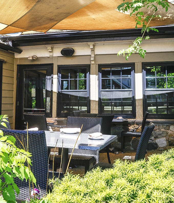The outdoor patio whispers promises of al fresco dining perfection, where summer breezes complement every bite and sip.