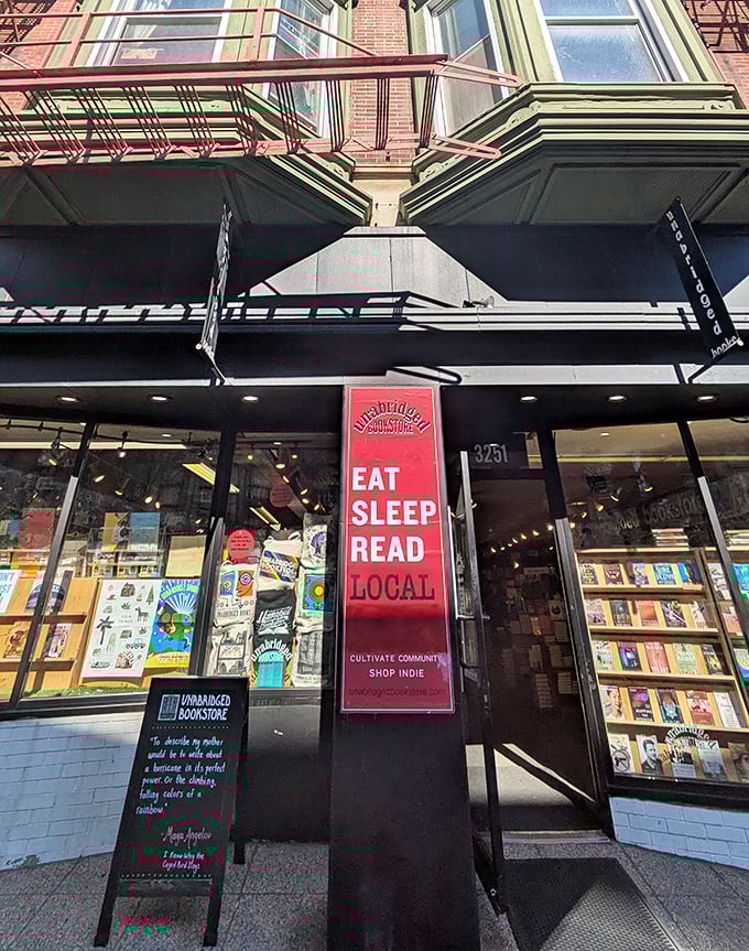 EAT SLEEP READ LOCAL&mdash;the bookstore's red banner manifesto hangs like a revolutionary flag for the literary resistance against digital domination.