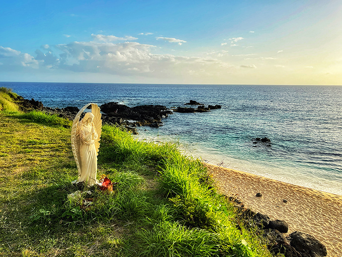 A serene statue stands sentinel at the shoreline, offering a moment of reflection amid nature's wild beauty.